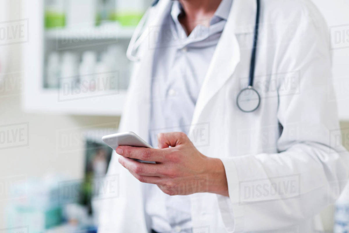 Doctor in hospital holding mobile phone - Royalty-free Stock Photo ...