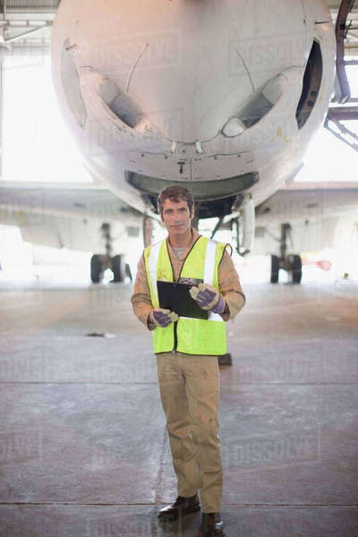 Aircraft worker standing on airfield - Royalty-free Stock Photo | Dissolve