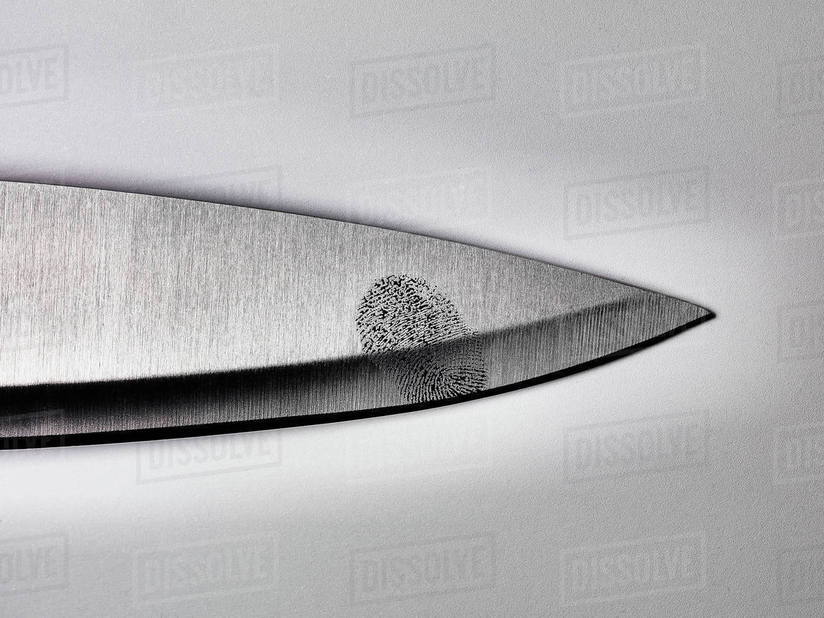Close up of fingerprint on knife blade - Stock Photo - Dissolve