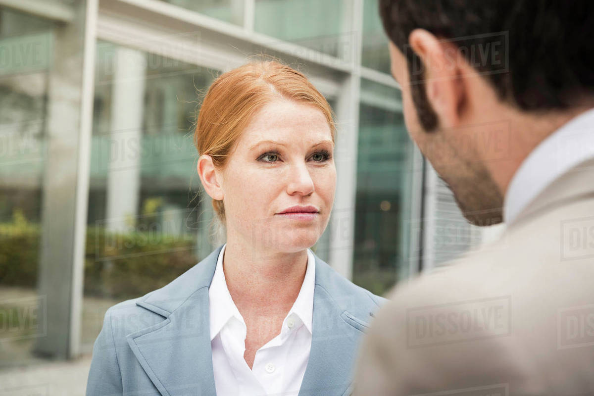 Business people talking on city street - Stock Photo - Dissolve