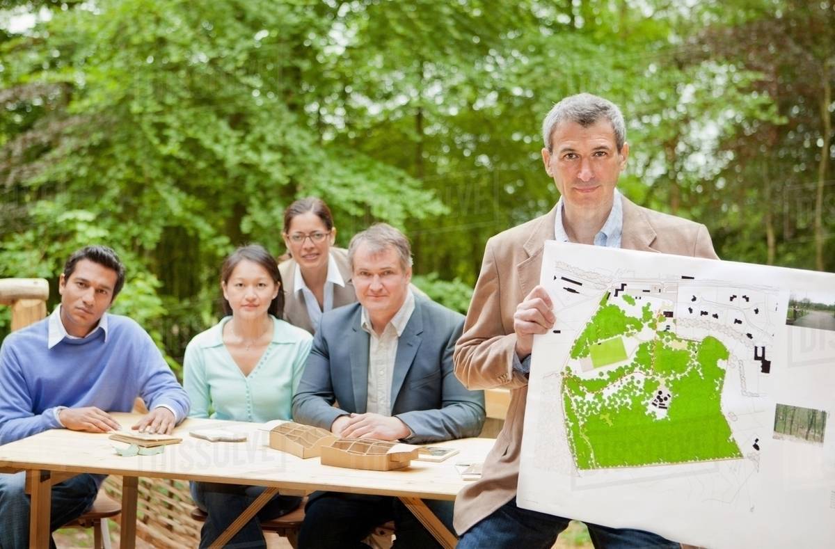 Businessman with map in meeting - Royalty-free Stock Photo | Dissolve