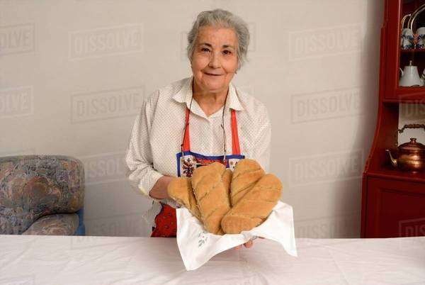 Older woman making bread in living room - Royalty-free Stock Photo ...