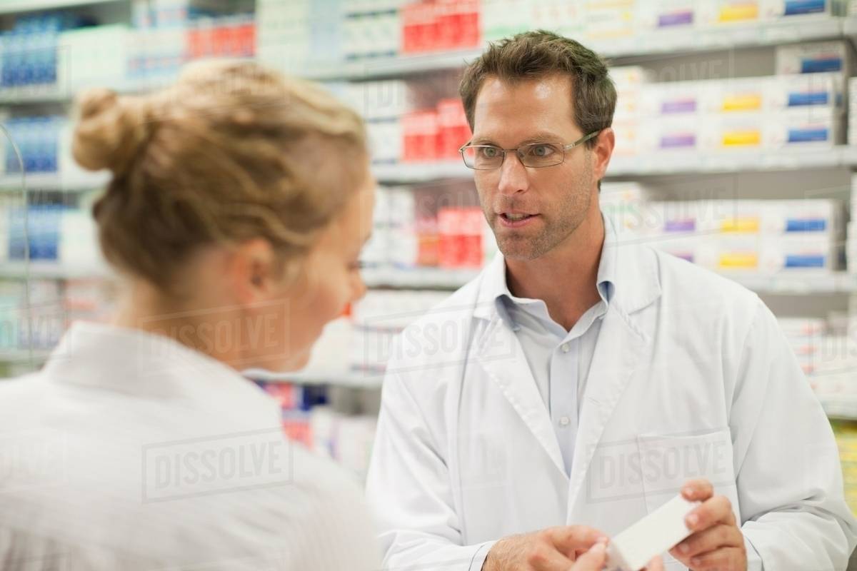 Pharmacist teaching patient about drug - Stock Photo - Dissolve