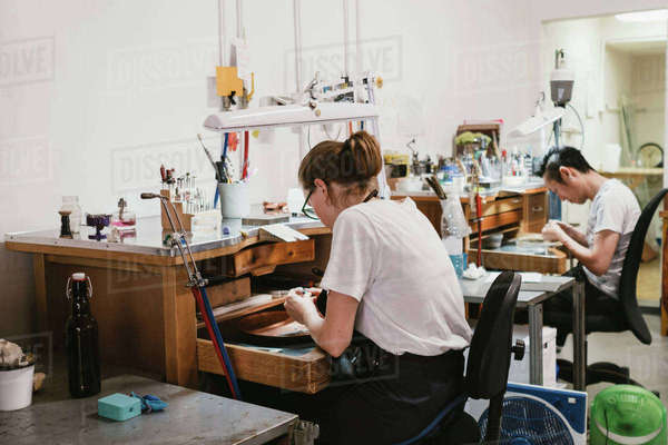 Female and male jewellers working at workbench - Royalty-free Stock ...