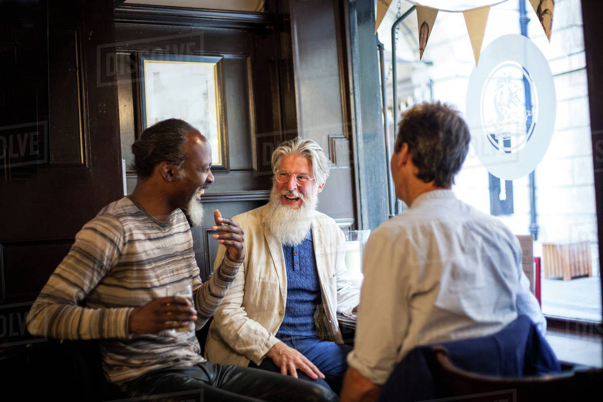 Three mature men, sitting together in pub, talking - Royalty-free Stock ...