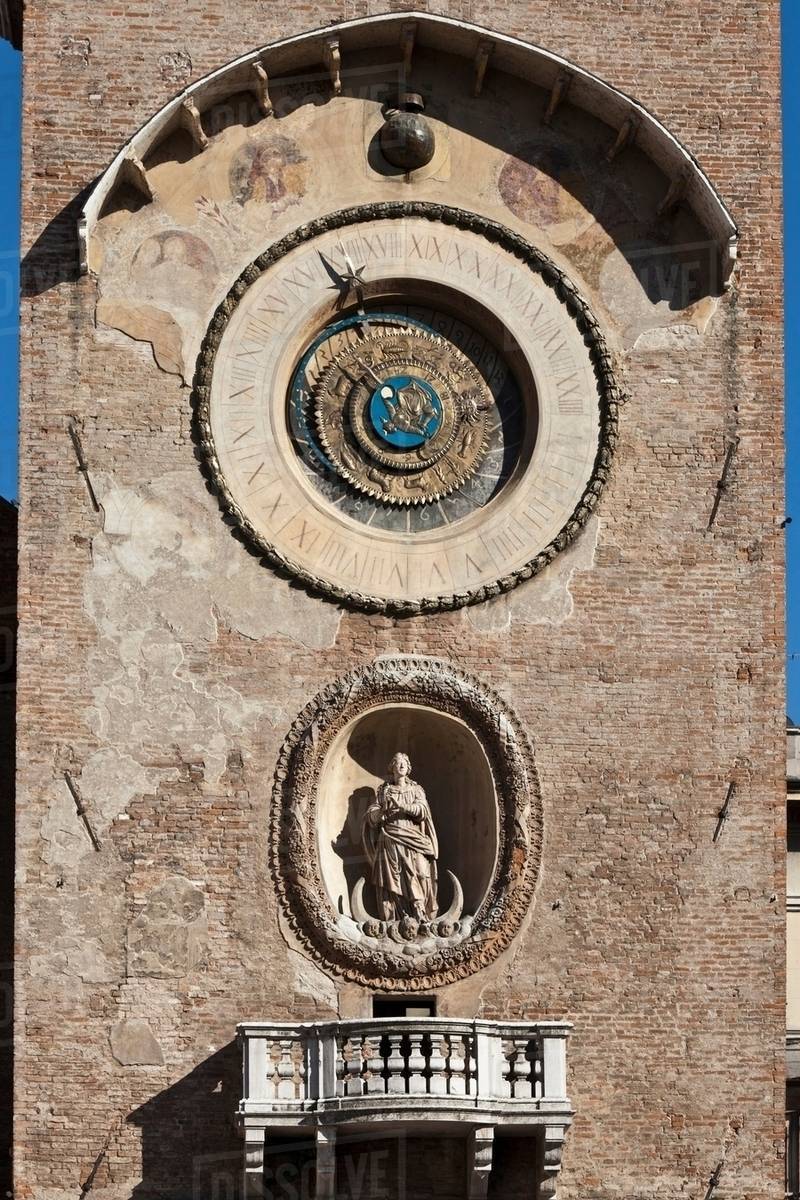 Ornate clock and statue on tower - Stock Photo - Dissolve