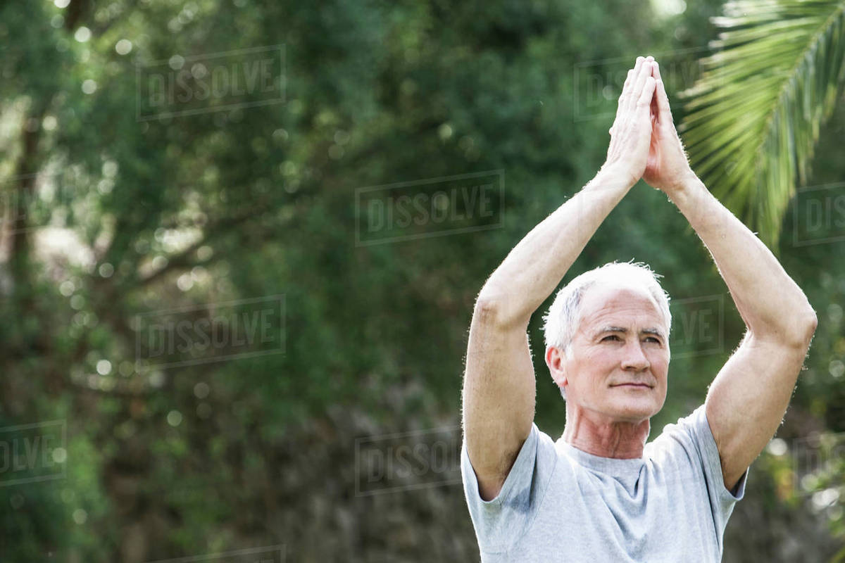 Man, hands together, arms raised in yoga position - Royalty-free Stock ...