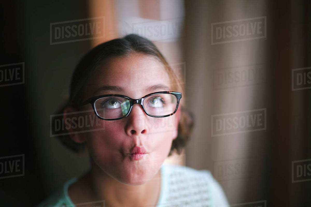 Girl puckering, making faces - Stock Photo - Dissolve