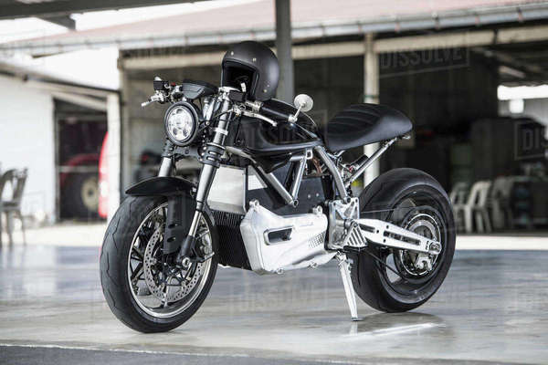Electric cafe racer motorbike on race track - Stock Photo - Dissolve