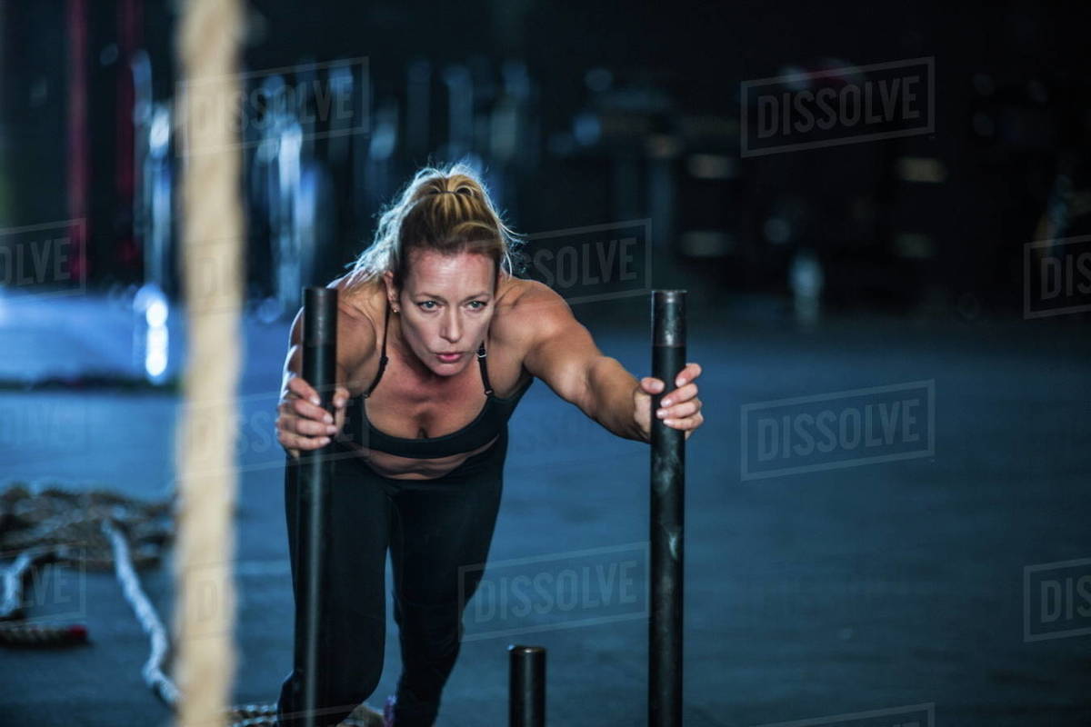 Woman exercising in gymnasium, sled training - Royalty-free Stock Photo ...