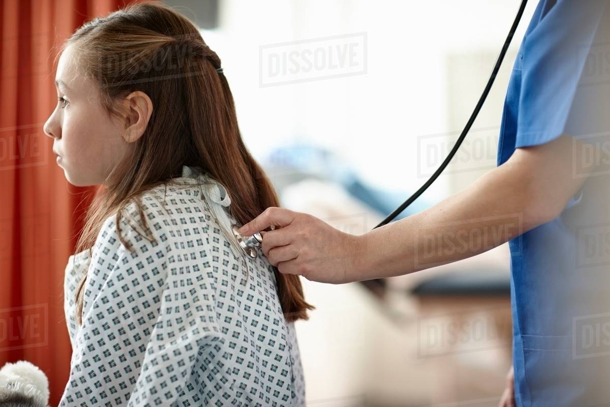 Nurse using stethoscope on girl - Royalty-free Stock Photo | Dissolve