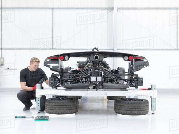 Male engineer assembling supercar in sports car factory - Stock Photo ...