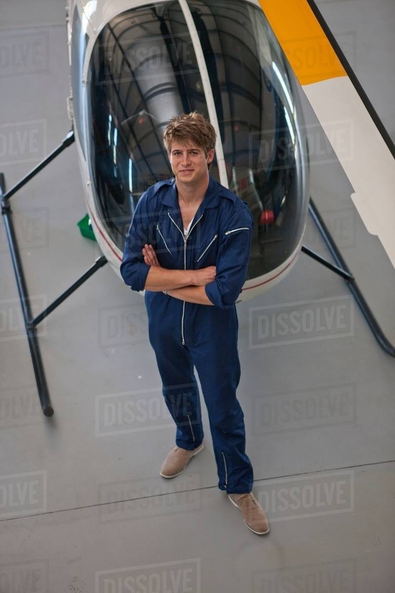 Student pilot posing in front of helicopter - Stock Photo - Dissolve