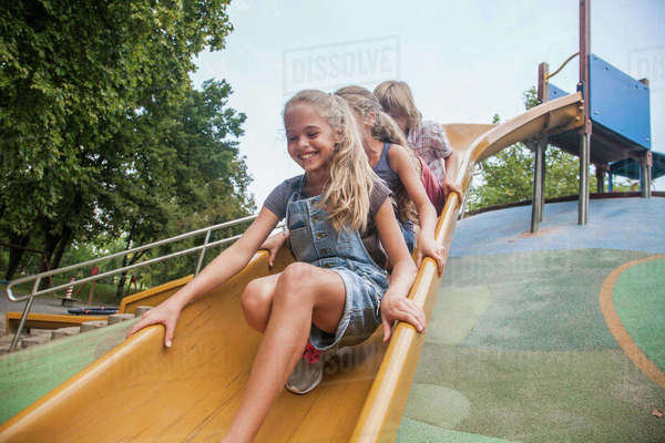 Children playing on slide - Stock Photo - Dissolve