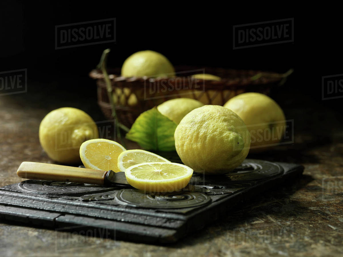 Whole and sliced unwaxed lemons - Stock Photo - Dissolve