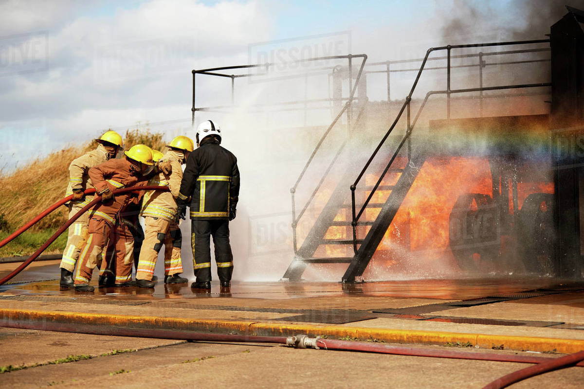 Firemen training, firemen spraying water at training facility stairway ...