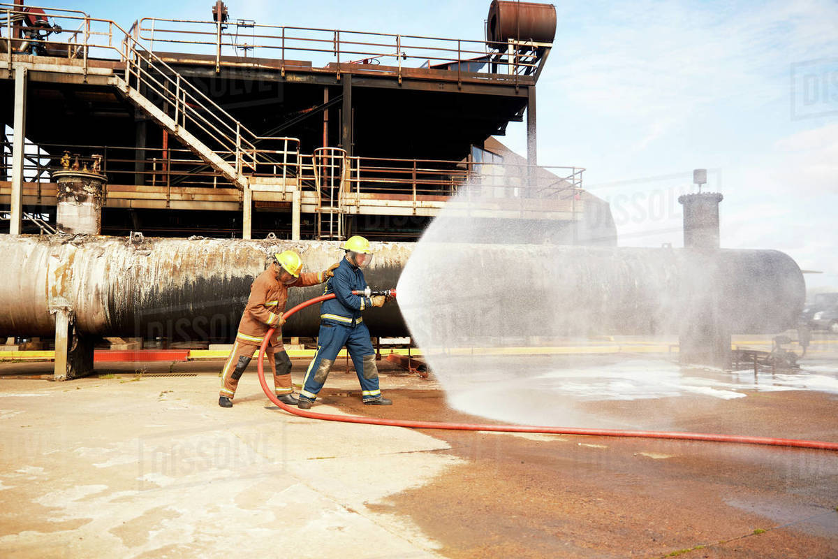 Firemen training, firemen spraying water from fire hose at training ...