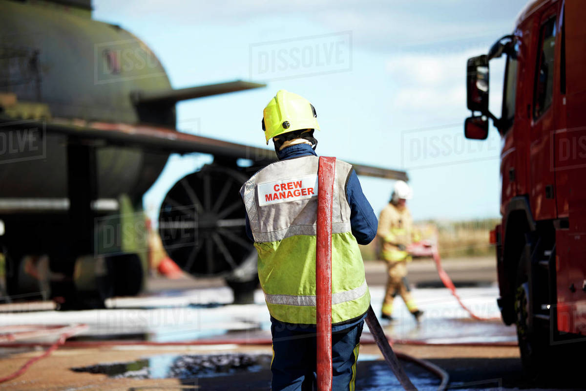Fireman carrying fire hose over shoulder, Darlington, UK - Royalty-free ...
