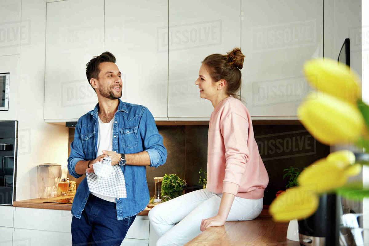 Couple talking in kitchen - Royalty-free Stock Photo | Dissolve