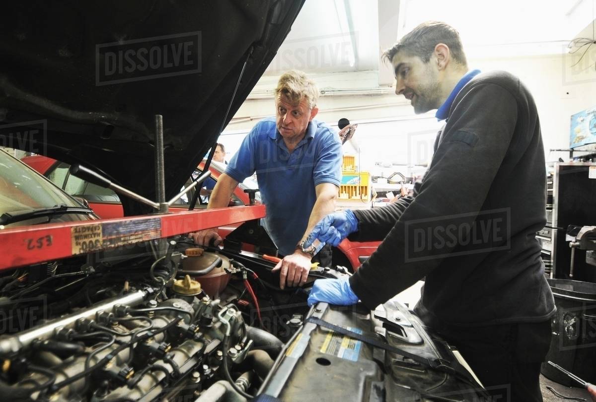 Mechanic checking car engine - Stock Photo - Dissolve