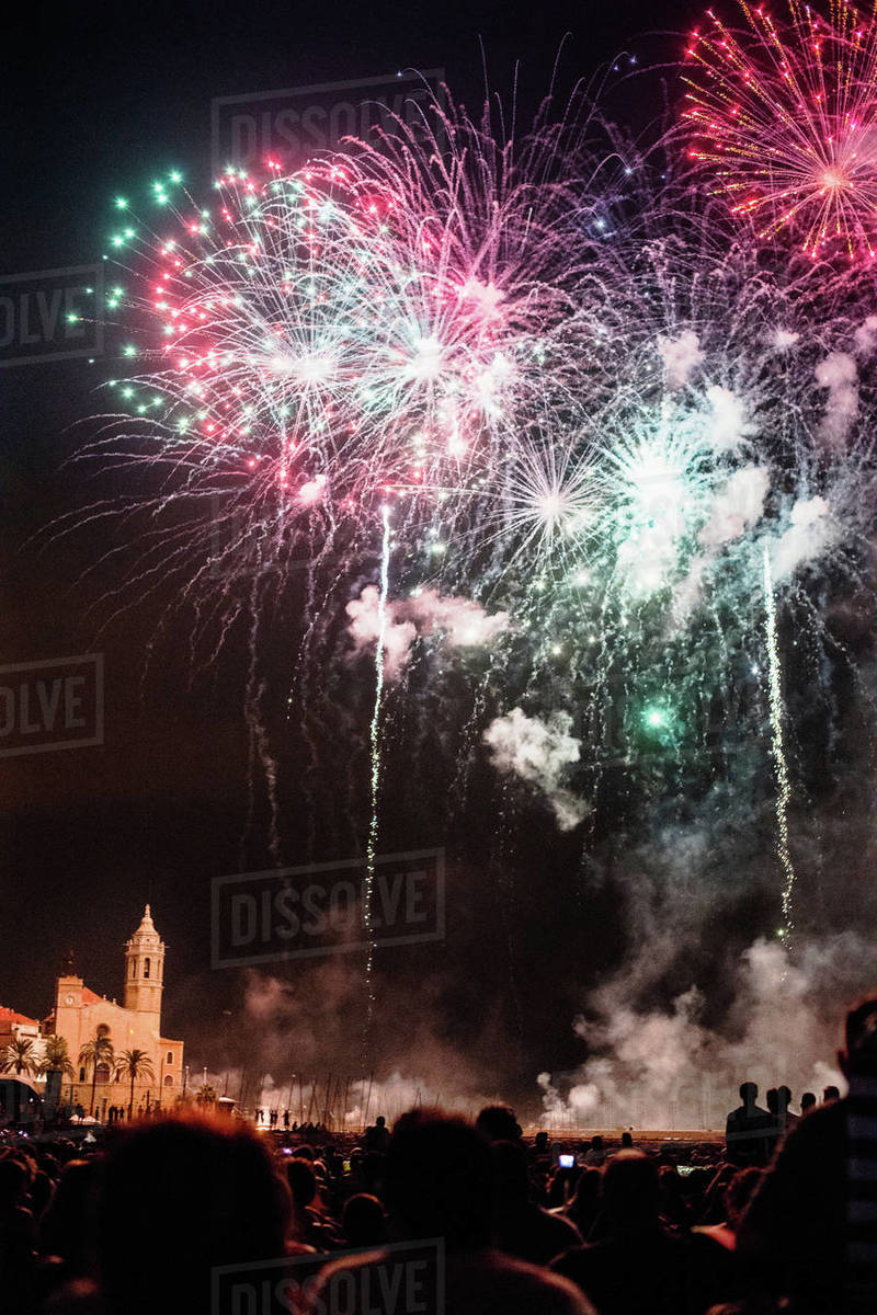 Group of people watching fireworks display at night - Stock Photo ...