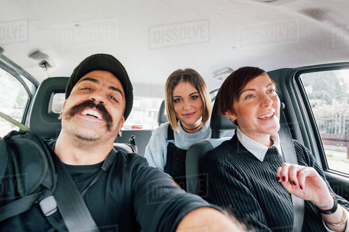 Friends laughing in car - Stock Photo - Dissolve