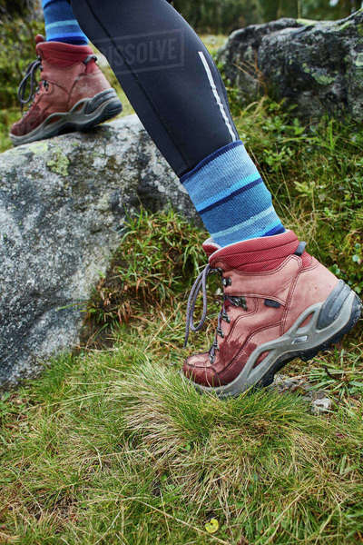 Female hiker stepping onto rock, close up of hiking boots - Stock Photo ...