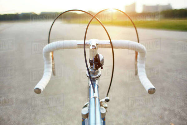 Racing bike on rural road, personal perspective view of handlebars ...