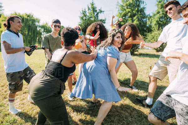 Group of friends dancing in park - Royalty-free Stock Photo | Dissolve