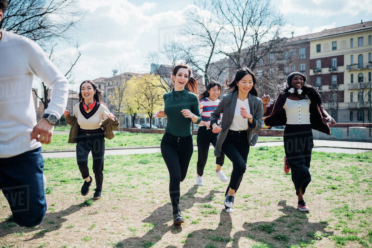 Young male and female adults running in park - Royalty-free Stock Photo ...