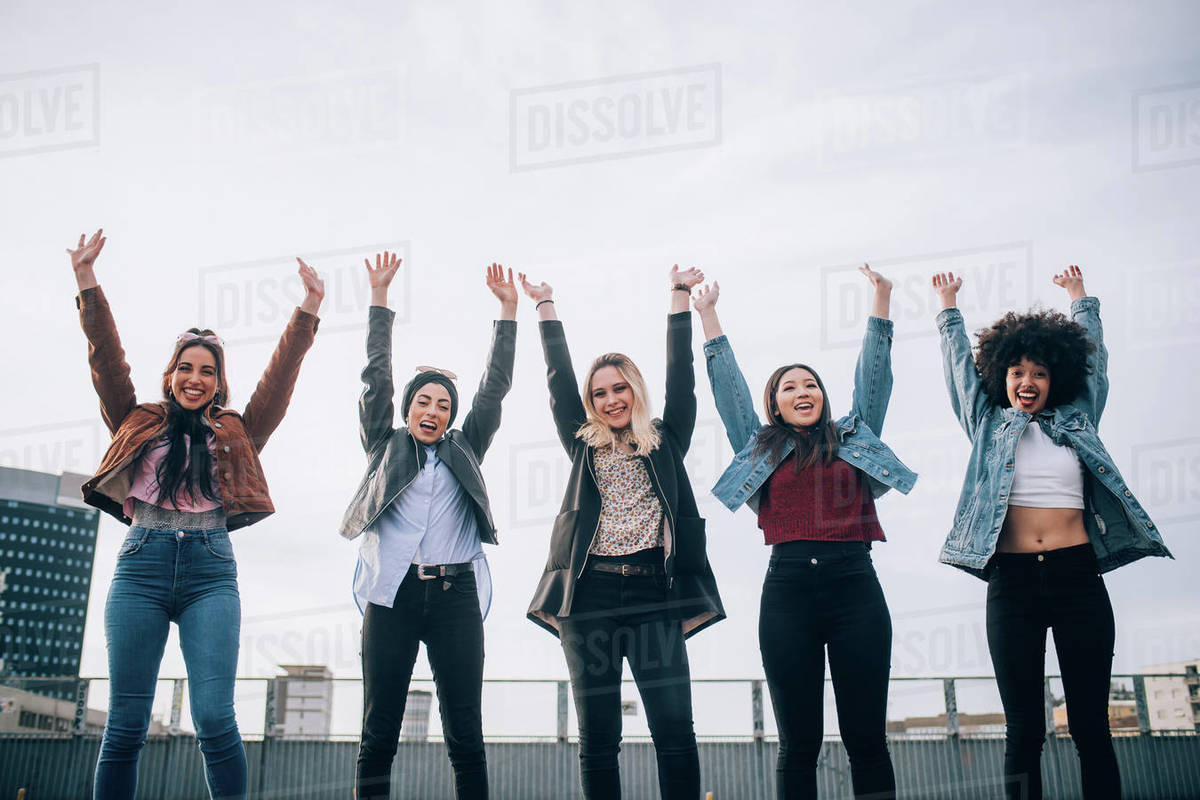 Friends raising arms in triumph in street, Milan, Italy - Royalty-free ...