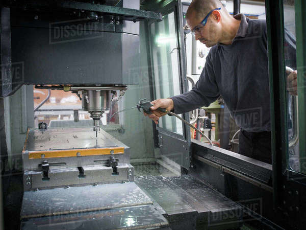 Knife factory worker operating cutting machinery - Royalty-free Stock ...