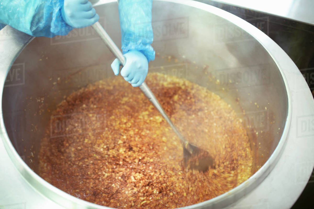 Worker stirring batch of food in food factory, close up - Stock Photo ...