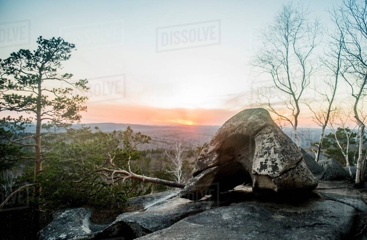 Mountain rock formation and fallen tree at sunset - Royalty-free Stock ...