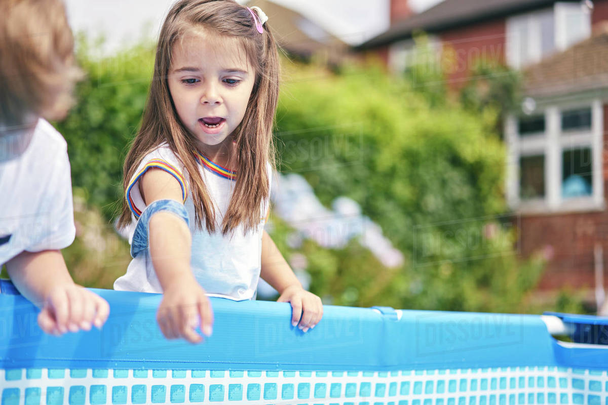 Girl pointing into pool - Royalty-free Stock Photo | Dissolve