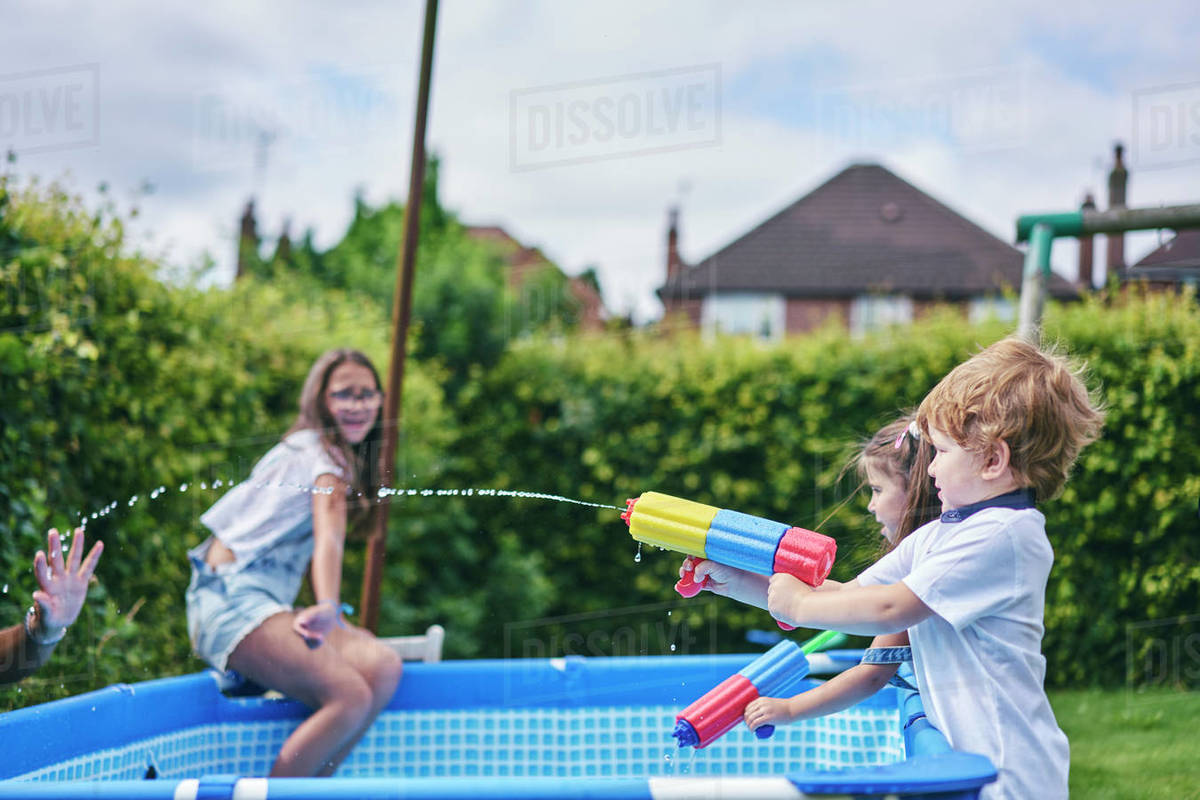 Children playing with water gun by pool - Royalty-free Stock Photo ...