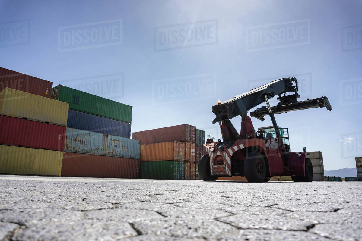 Reach stacker and shipping containers in dock - Royalty-free Stock ...