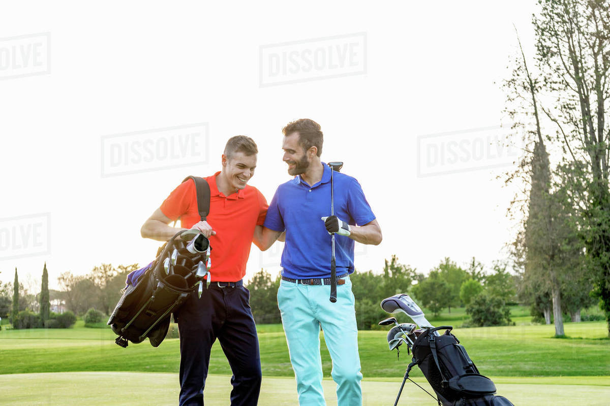 Friends talking and laughing on golf course - Royalty-free Stock Photo ...