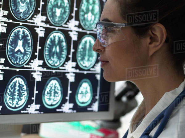 Neurology Diagnosis, Human brain scan on a screen being analysed by a ...