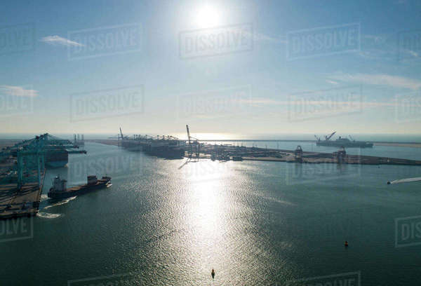 Aerial view of docks with ships out to sea. - Stock Photo - Dissolve