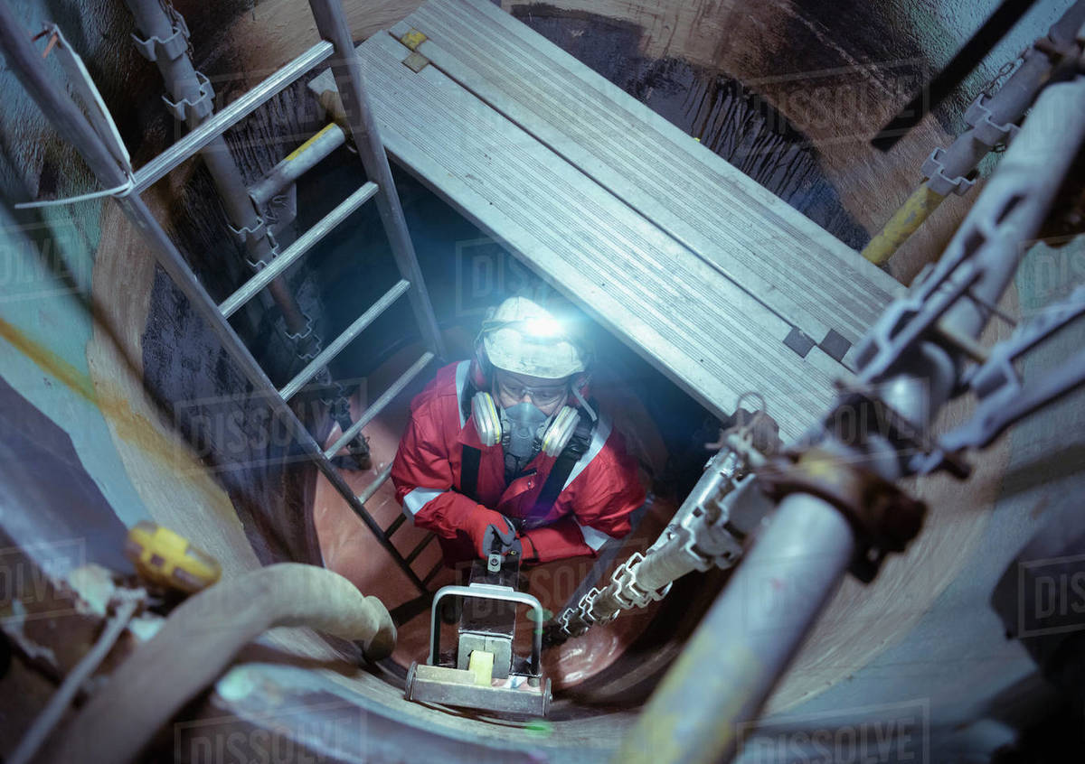 Engineer cleaning a tank in a nuclear power station. - Stock Photo ...