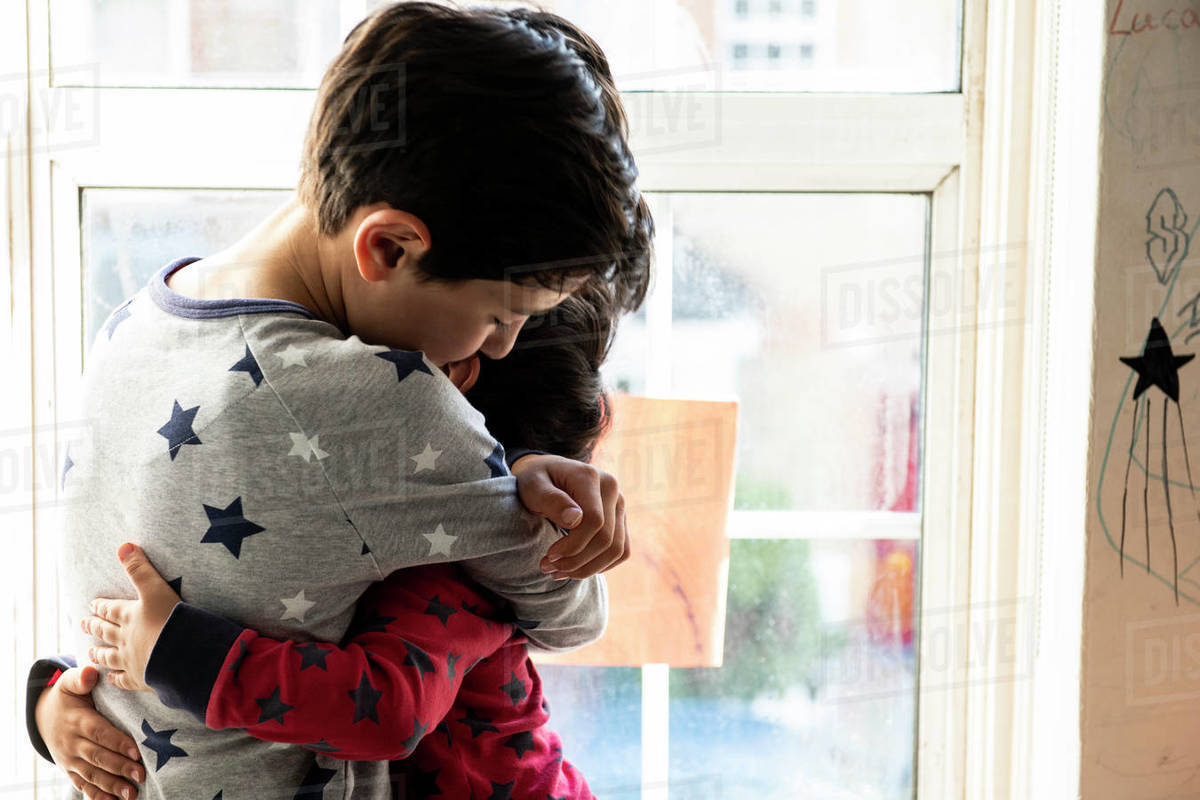 Two boys, brothers hugging each other. - Stock Photo - Dissolve