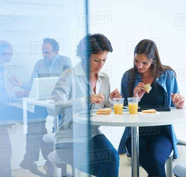 Business people having discussion over lunch - Stock Photo - Dissolve