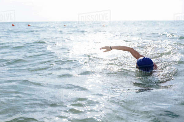 Man swimming in sea - Stock Photo - Dissolve