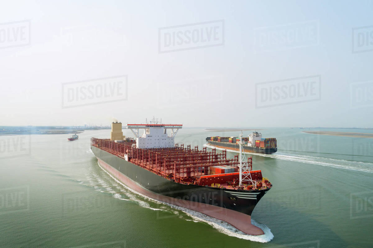 A 400m long container ship sails to the port of Antwerp, passing ...