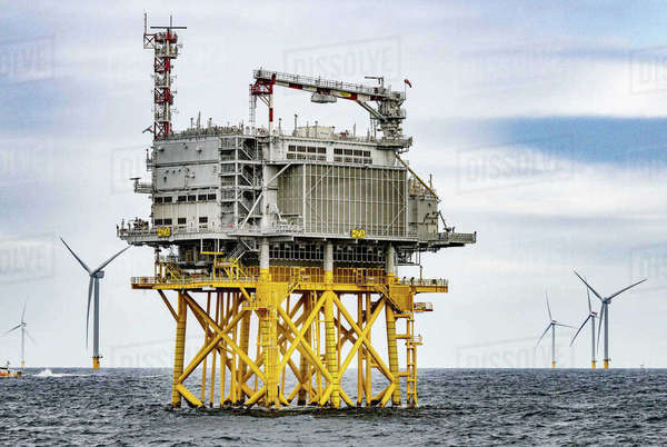Offshore wind farm and platform standing amidst the waves - Royalty ...