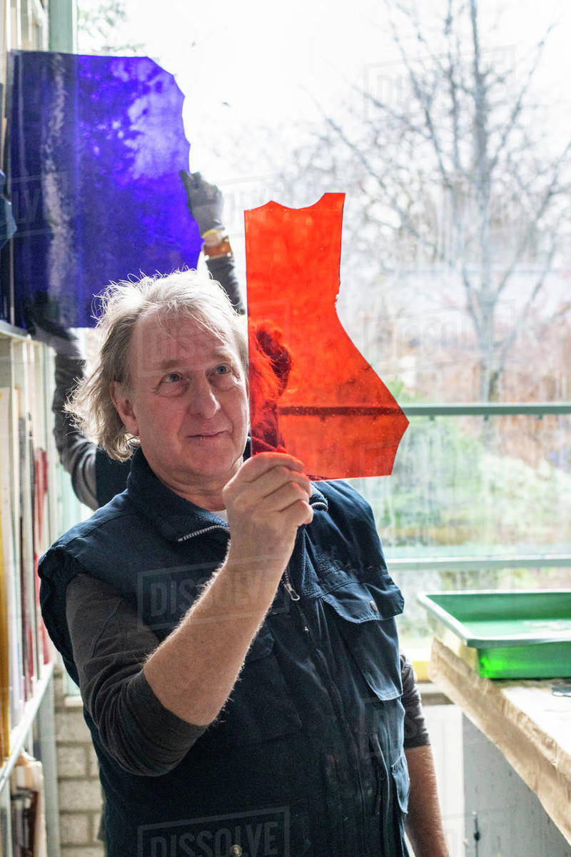 Adult male master stain glass workman inspecting - Royalty-free Stock ...