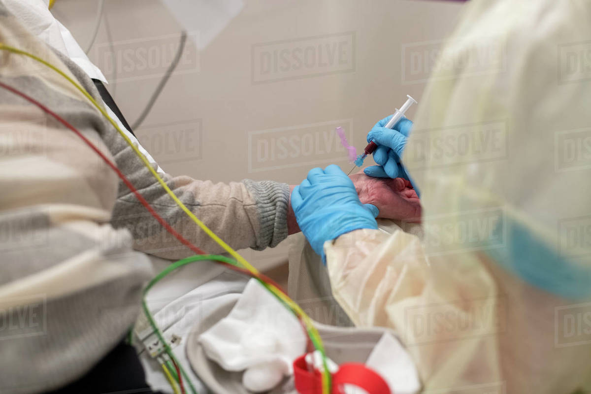 Elderly lady in a hospital bed under observation with healthy issues ...