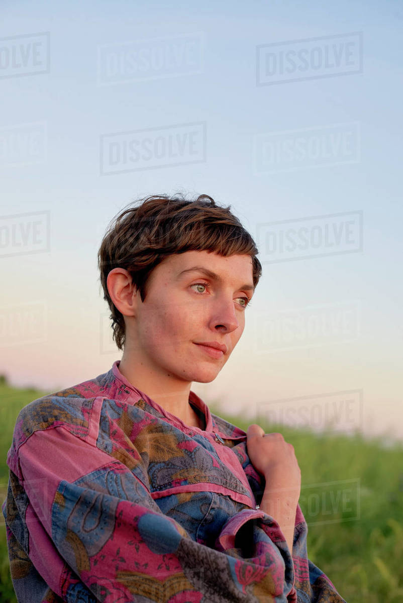 An industrial complex with large storage tanks and a tall chimney stack ...