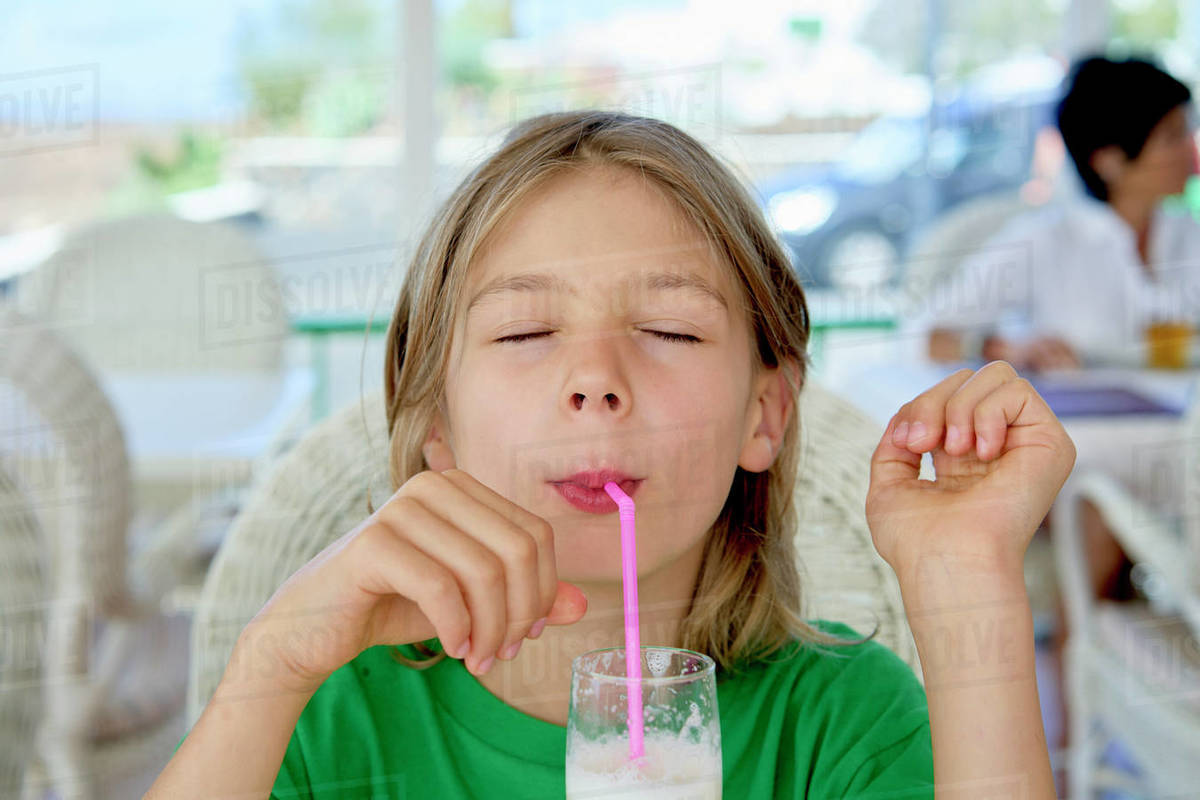 A person stands on a rocky overlook gazing out at a scenic coastal ...